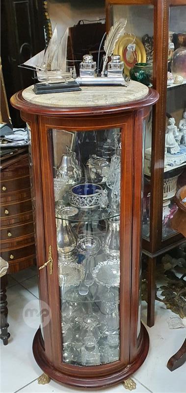 A beautiful large round glass showcase with marble top and glass ...
